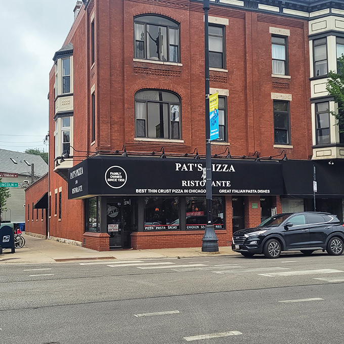 The iconic red brick corner building housing Pat's Pizza & Ristorante stands as a beacon of culinary promise in Chicago's Lincoln Park neighborhood.