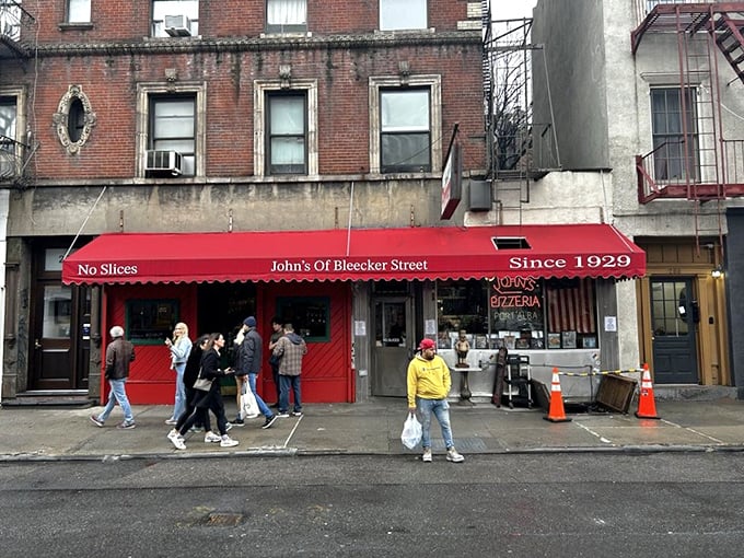 The iconic red awning of John's proudly declares "No Slices" &ndash; a battle cry that separates the pizza tourists from the true believers.