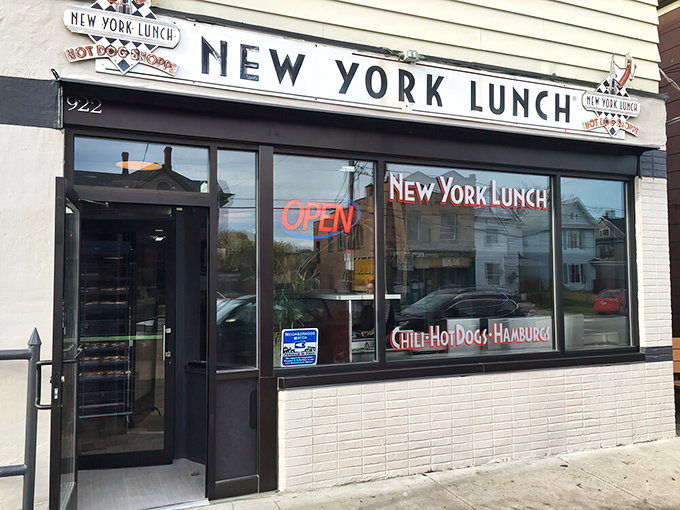 The classic storefront of New York Lunch on East Avenue beckons with its vintage sign and promise of "Chili-Hot Dogs-Hamburg" – a time capsule of American diner culture.