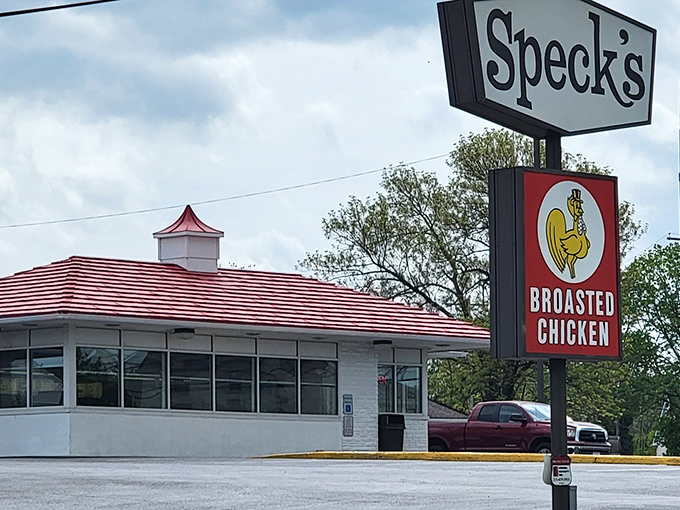The iconic red-striped roof and vintage sign at Speck's Drive-In stand as beacons of broasted chicken perfection in Collegeville, Pennsylvania.