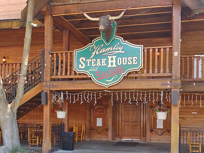 The iconic Hamley Steakhouse & Saloon sign welcomes hungry travelers with its distinctive longhorn skull and rustic wooden charm. Western hospitality at its finest.