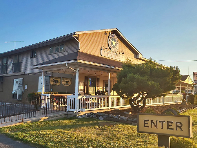 Bathed in golden sunset light, this angle of Dodge City showcases its inviting porch and unmistakable star logo&mdash;a beacon for steak lovers.