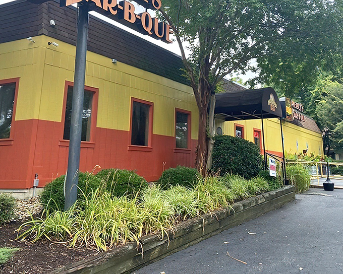 The unmistakable yellow and orange exterior of Pierce's stands out like a barbecue beacon, promising smoky delights within these vibrant walls.