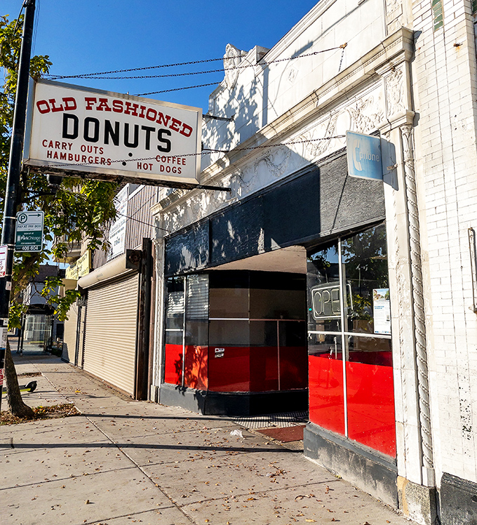The classic white-brick exterior with its distinctive red lower panels has welcomed generations of donut enthusiasts seeking handcrafted perfection.