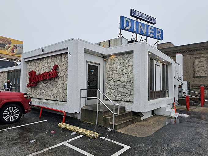 That iconic blue sign beckoning hungry travelers like a neon lighthouse &ndash; Llanerch's stone exterior says "come in, we've got what you need."