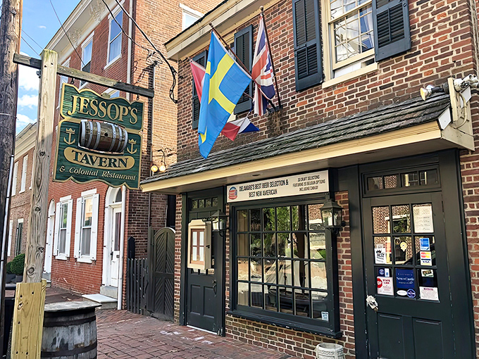 Flags flutter above Jessop's brick facade like colorful sentinels guarding a portal to colonial America. The evening glow transforms this historic tavern into pure magic.