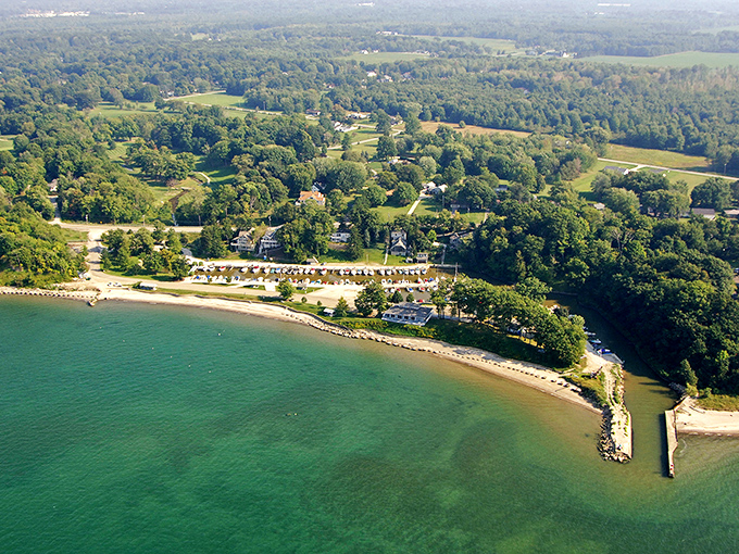 Lake Erie's turquoise waters meet lush green shores in a view that rivals any ocean postcard you've ever pretended to send.