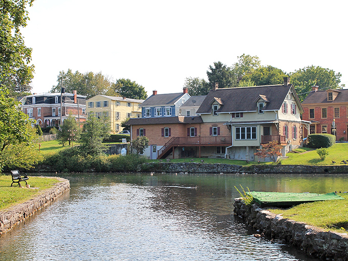 Historic homes embrace Children's Lake like old friends at a reunion, their reflections dancing in waters fed by limestone springs.