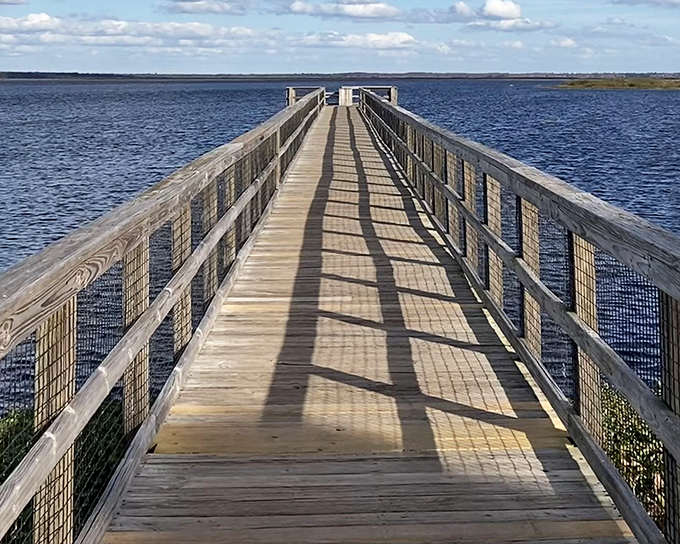 The wooden boardwalk stretches toward infinity, inviting you to leave your worries on shore and venture into Florida's wild heart.