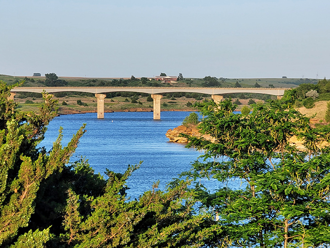 The bridge stretching across Wilson Lake creates a postcard-perfect scene that makes you wonder why you ever waste time scrolling through social media when this exists.