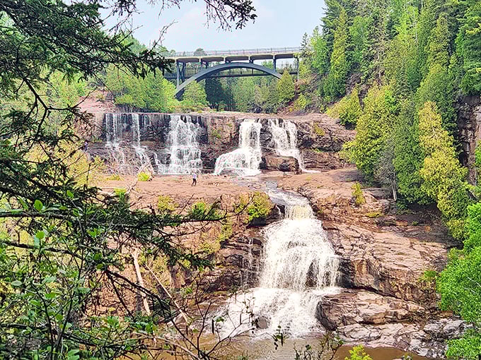 Mother Nature showing off her multi-tiered masterpiece. The iconic Highway 61 bridge frames Gooseberry's cascading falls like nature's perfect postcard moment.