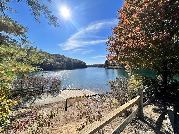Lake Keowee's crystal waters reflect the Carolina sky like nature's own mirror. The wooden dock invites you to sit and contemplate life's big questions&mdash;or just enjoy the view.