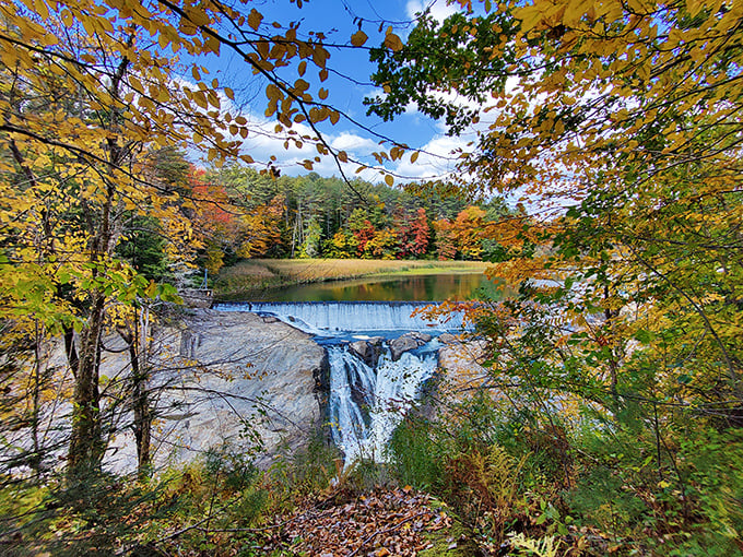 Nature's perfect autumn canvas unfolds at Quechee, where the waterfall provides both soundtrack and spectacle to Vermont's seasonal color explosion.