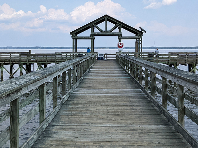 The fishing pier stretches toward possibility, inviting both serious anglers and daydreamers to venture beyond the shoreline into tranquility.