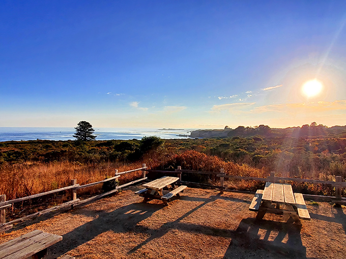 Sunset picnic perfection. These weathered tables offer front-row seats to nature's daily masterpiece, where ocean meets sky in a spectacular coastal light show.