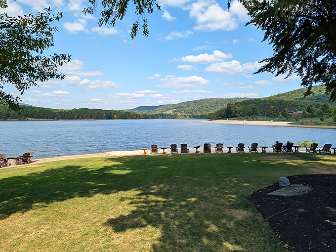 Adirondack chairs lined up like eager spectators, waiting for nature's daily performance across Lake Habeeb's shimmering stage.