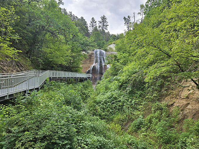 Nature's grand reveal: Smith Falls emerges from its lush green setting like Nebraska's best-kept secret, a 70-foot cascade waiting to take your breath away.