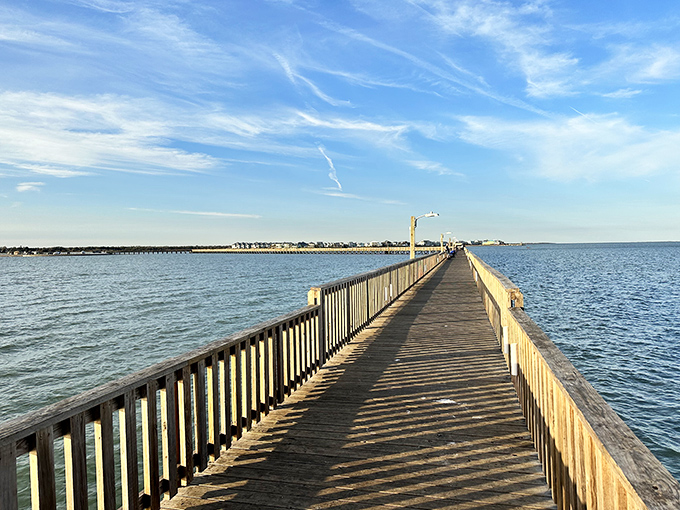 The fishing pier stretches toward infinity like a wooden runway to paradise. Sunlight dances on the water, promising adventures that don't require a passport.