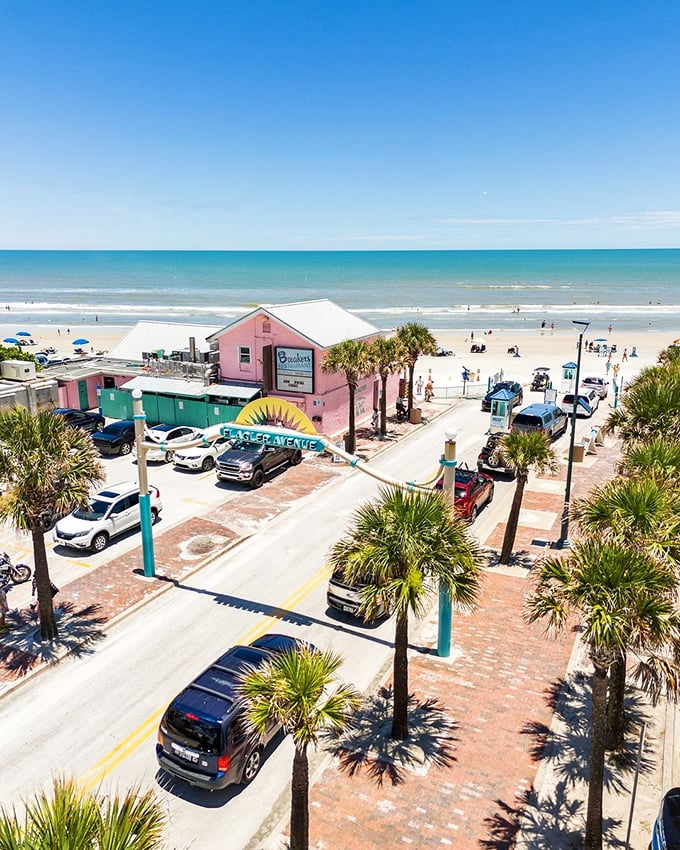 Beachfront bliss where palm trees stand guard and the pink building serves as a landmark for locals saying, "Turn at the pink place and you'll find us."