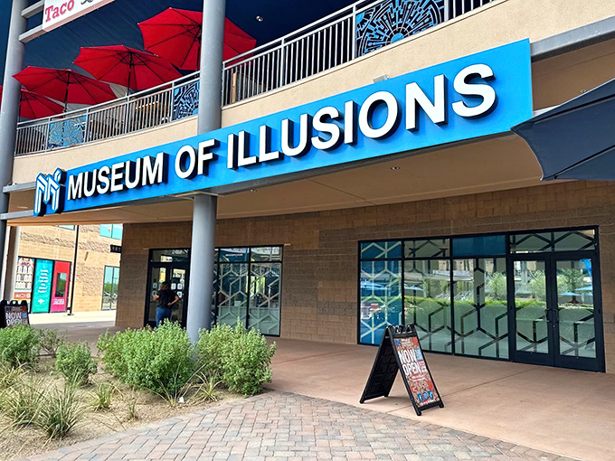The blue neon sign beckons curious minds into Scottsdale's playground of perception. Desert landscaping outside, mind-bending wonders inside.
