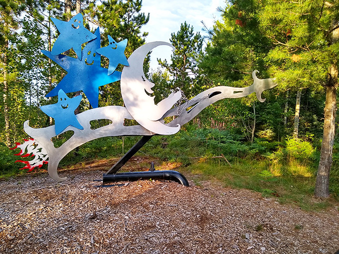 A cosmic dancer leaps through the forest, its metallic body catching sunlight as it reminds visitors that art knows no earthly bounds.