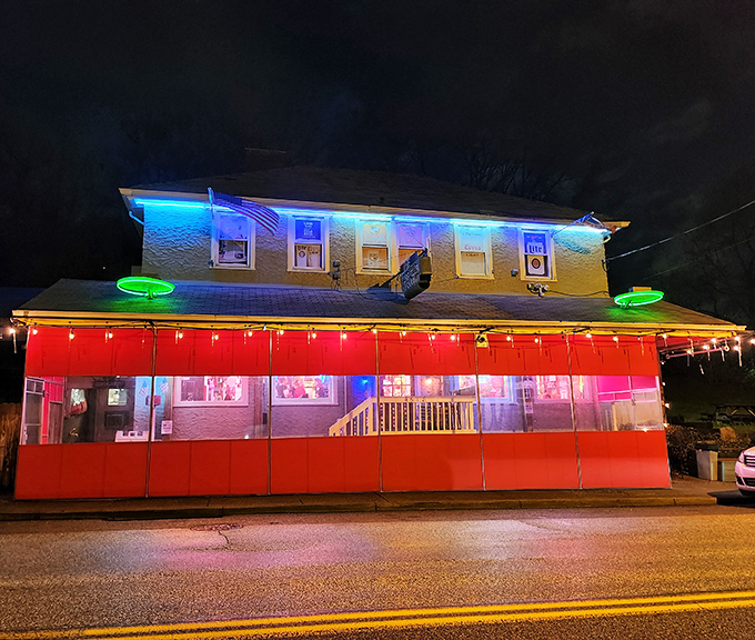 The neon-drenched exterior of The Turf Club glows like a beacon in the night, promising culinary adventures and good times within Cincinnati's east side.