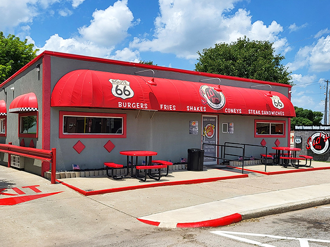 The bright red awning of Sid's Diner stands out like a beacon on Route 66, promising burger salvation to weary travelers and locals alike.