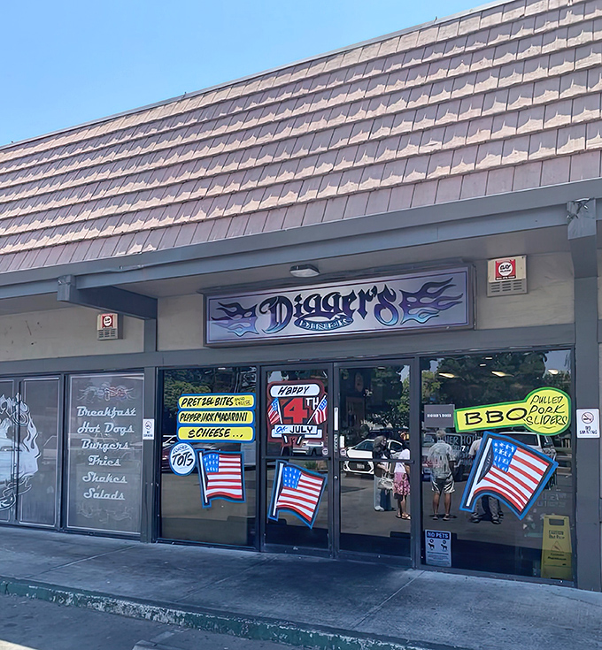 Patriotic flair meets diner charm at Digger's exterior. Those flags aren't just decoration&mdash;they're promising you the all-American comfort food experience waiting inside.