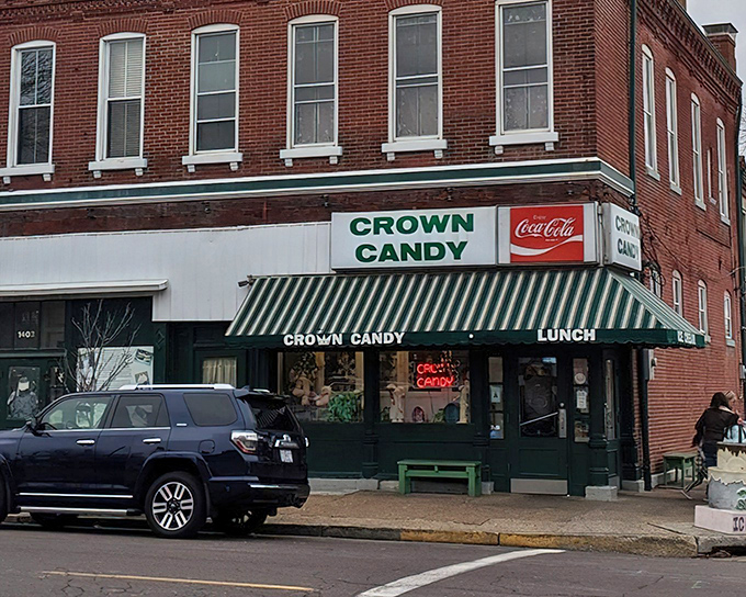 The iconic green awning of Crown Candy Kitchen beckons like a time portal to simpler days when ice cream solved all of life's problems.