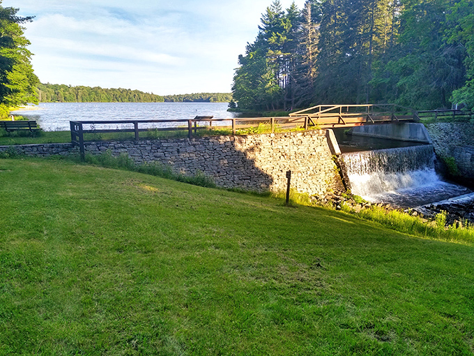 The stone dam at Promised Land creates a perfect postcard moment. Nature's engineering meets human craftsmanship in peaceful harmony.