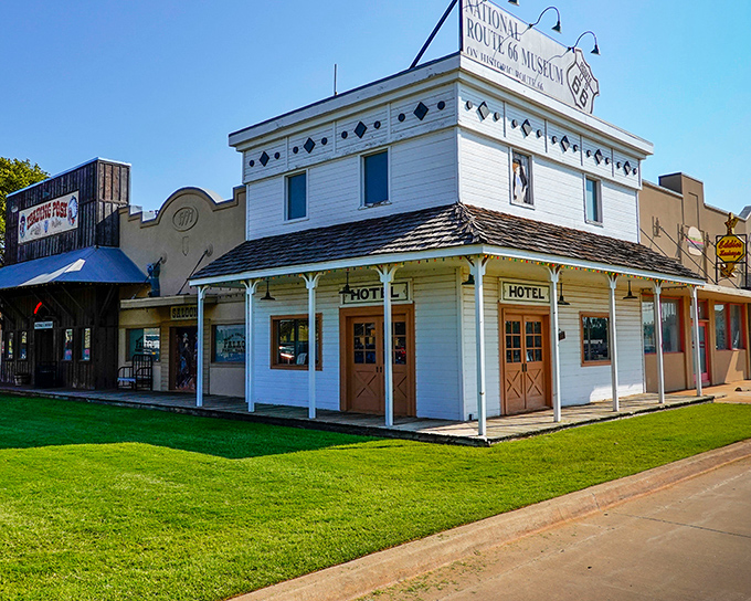 The classic white facade of the National Route 66 Museum stands like a time portal to America's golden age of highway travel.