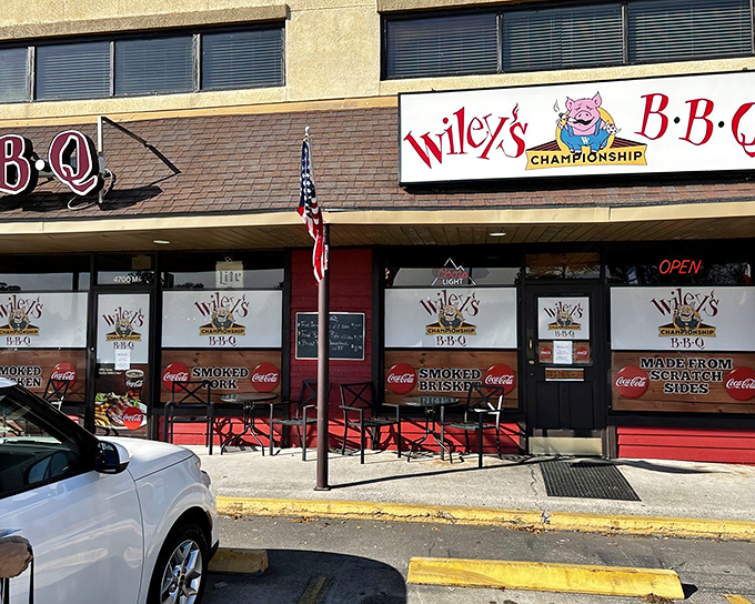 Where barbecue dreams come true! The American flag stands proudly alongside a sign that promises championship-level meat mastery.