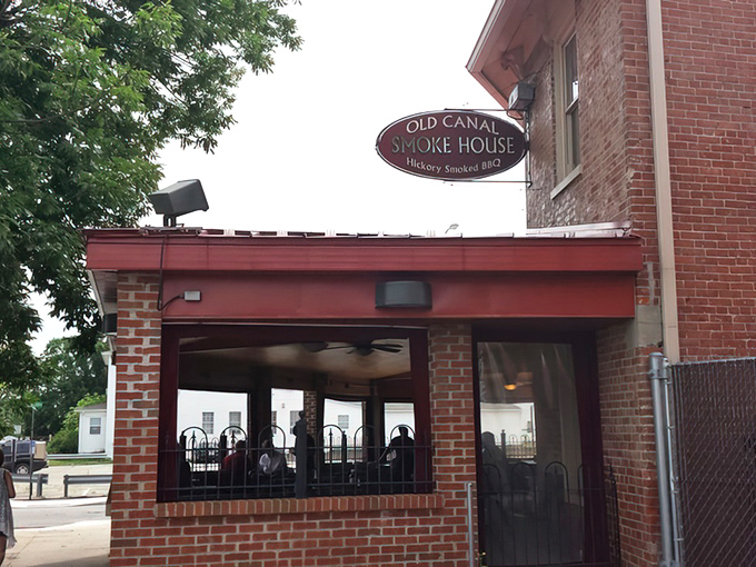 That classic oval sign promises hickory-smoked delights within—like a treasure map where X marks the spot for your taste buds.