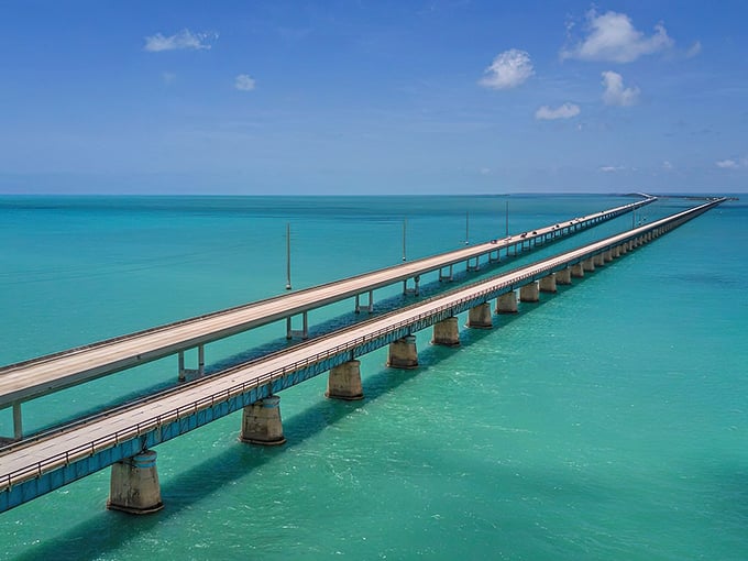 The engineering marvel that is the Seven Mile Bridge stretches toward infinity, a concrete ribbon floating between two perfect shades of blue.