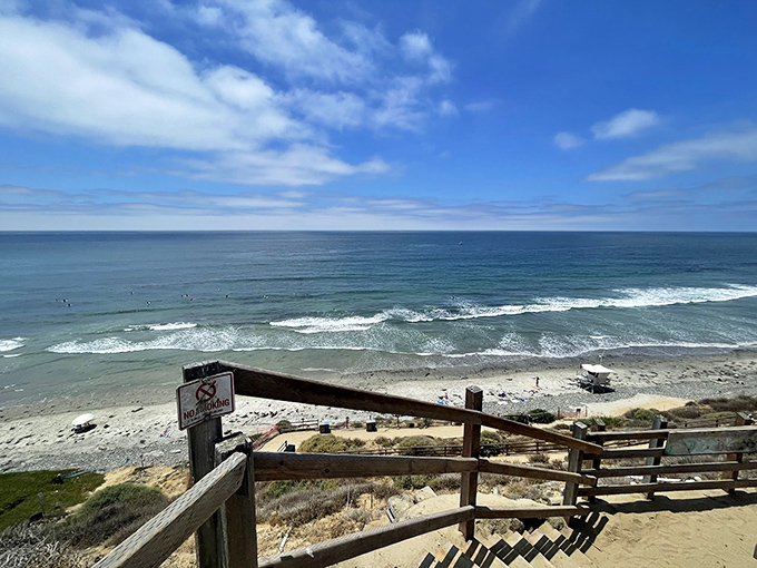 The wooden staircase winds down through coastal sage, revealing glimpses of the Pacific that'll make your heart skip.