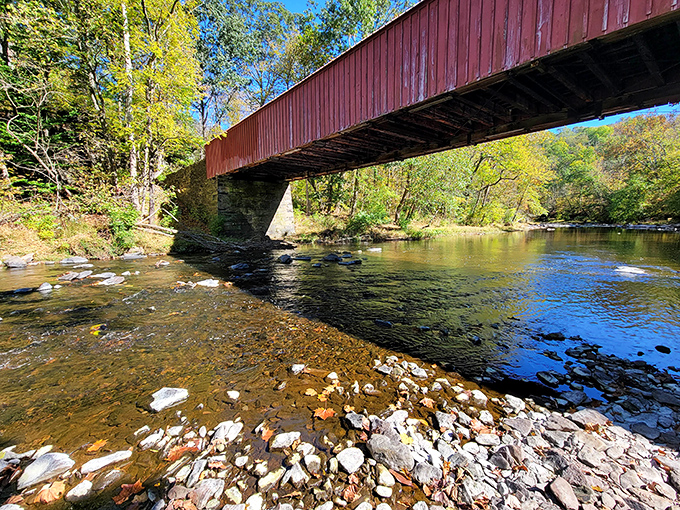 The iconic red bridge at Ralph Stover spans Tohickon Creek like a postcard come to life, inviting visitors to cross into adventure.