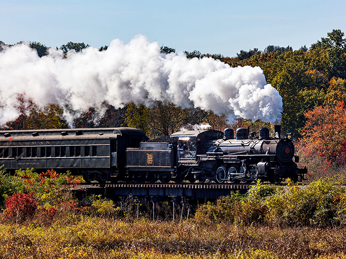 Steam and autumn foliage create nature's perfect marriage. This magnificent locomotive powers through Connecticut's fall landscape like a time machine on wheels.