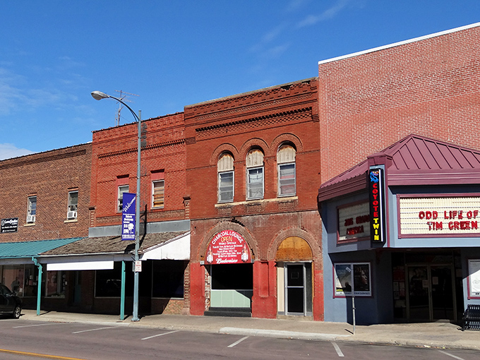 Historic brick facades line downtown Vermillion, where small-town charm meets college-town energy. The Coyote Twin marquee promises entertainment without the big-city price tag.