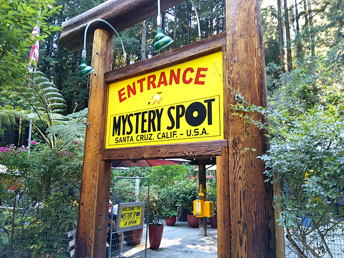 The iconic yellow and red entrance sign welcomes curious visitors to a world where physics takes a vacation and wonder reigns supreme.