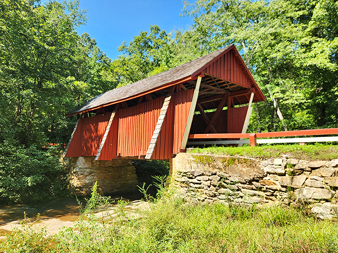 The iconic red siding of Campbell's Covered Bridge creates a striking contrast against South Carolina's lush greenery, like a cardinal perched among summer leaves.