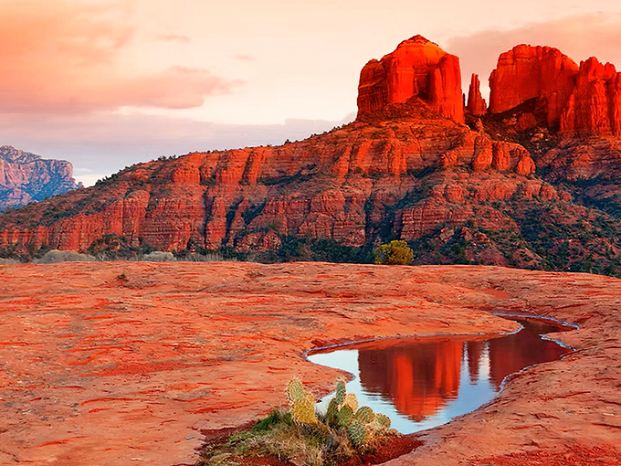 Sunset transforms these ancient formations into nature's lava lamp. The reflective pool captures the crimson glow, doubling the magic of this Sedona moment.