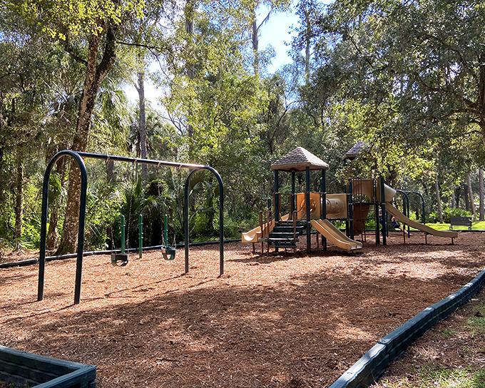 A playground nestled among towering trees &ndash; where kids can burn energy while parents enjoy nature's air conditioning.