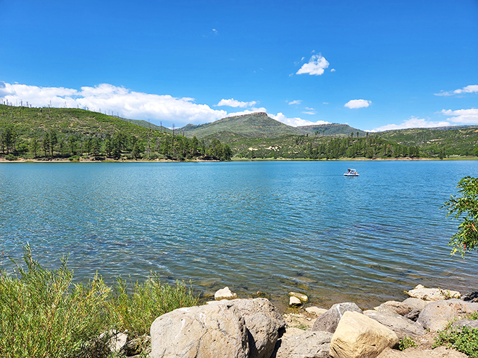 Lake Maloya's crystal waters mirror the surrounding mountains like nature's own Instagram filter. Pure New Mexico magic at its most serene.