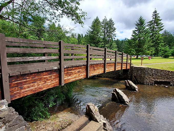 Rustic wooden bridges connect you to nature's wonders at Silver Falls, where every crossing feels like stepping into a storybook adventure.