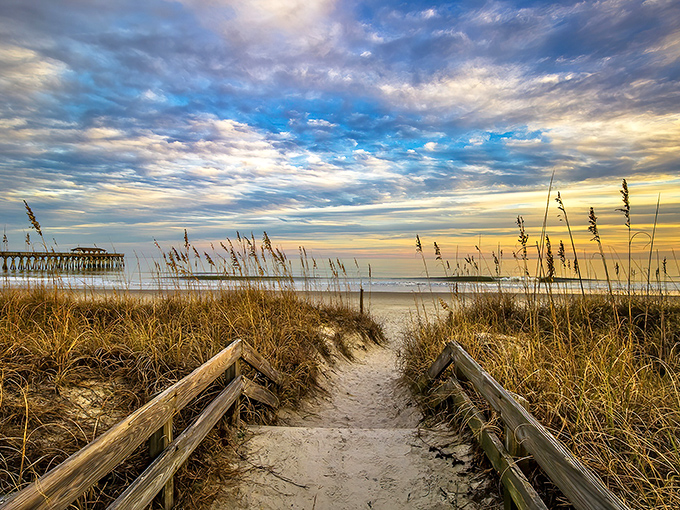 Nature's own welcome mat rolls out where sea oats dance and the pier stands like a patient fishing grandfather.