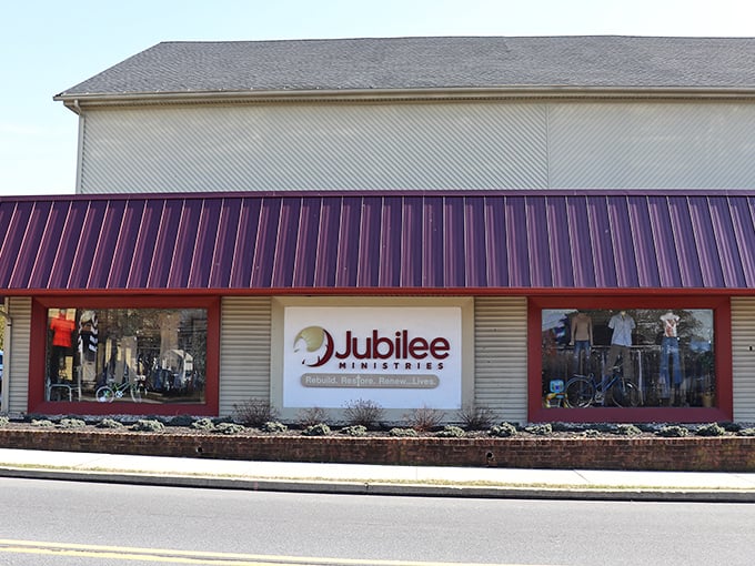 The welcoming storefront of Jubilee Ministries, with its distinctive burgundy awning and promise of treasures waiting inside. Like a secondhand Narnia, this unassuming entrance leads to a world of affordable wonders.