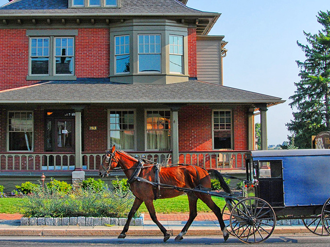 Where horse-drawn buggies and brick homes coexist in perfect harmony – a quintessential scene from Intercourse, Pennsylvania that feels like stepping into another era.