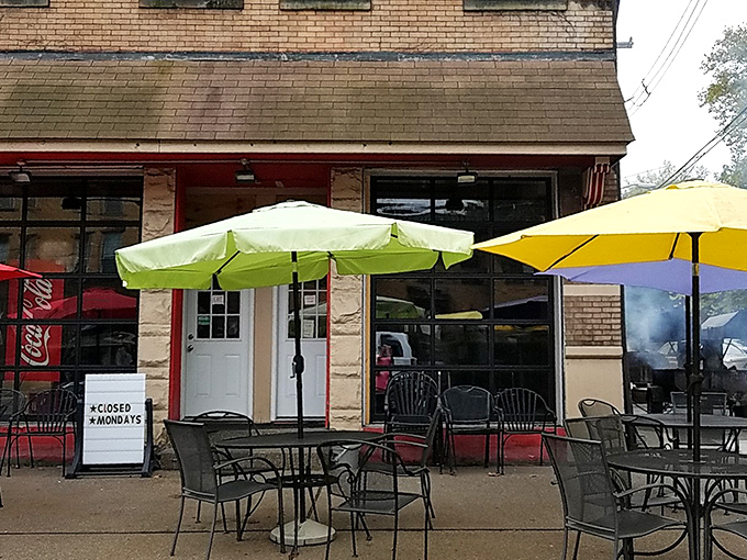 Colorful umbrellas dot the outdoor seating area, creating a cheerful oasis where the only thing more vibrant than the decor is the flavor of the barbecue.