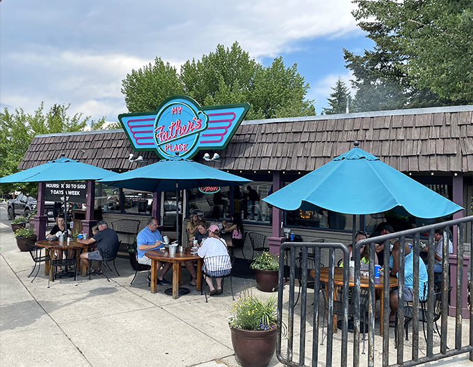 Summer dining perfection: Locals and visitors alike soak up Idaho sunshine under bright blue umbrellas while awaiting their charbroiled masterpieces.
