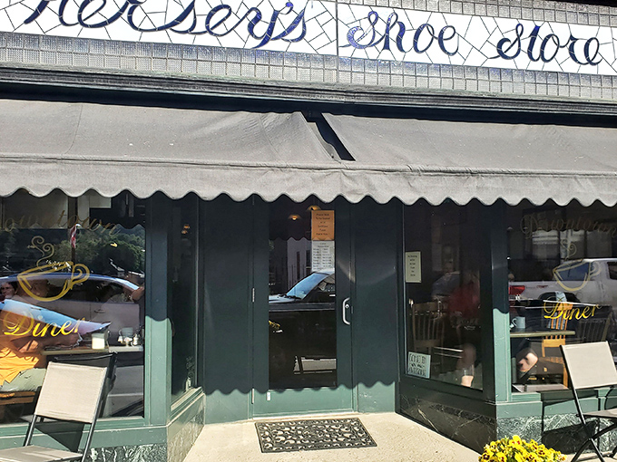 Hiding in plain sight beneath a shoe store sign, Downtown Diner's modest entrance belies the breakfast magic happening inside. Clark Kent vibes, Superman pancakes.